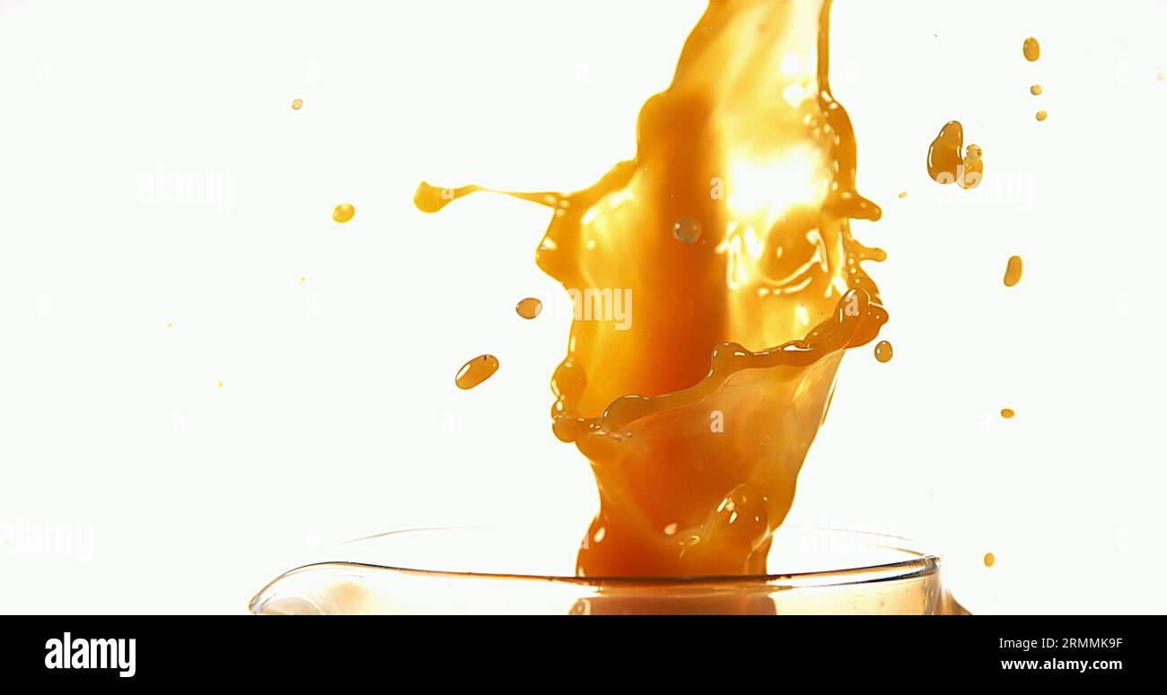 Orange Juice being poured into Glass against White Background Stock ...