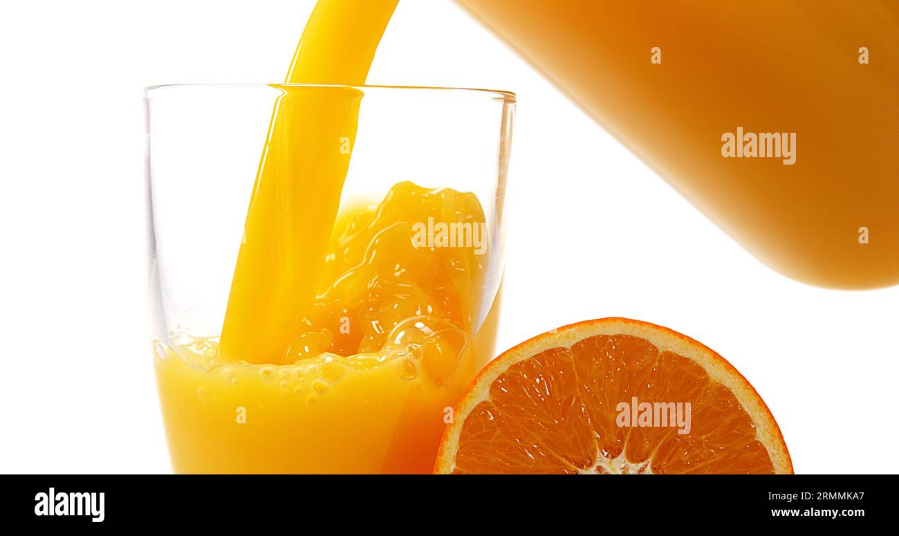 Orange Juice being poured into Glass against White Background Stock ...