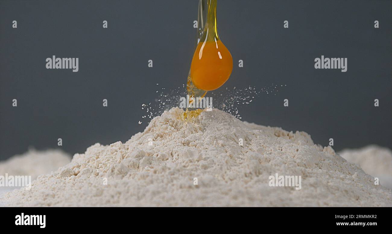 Egg Falling on Flour Stock Photo - Alamy