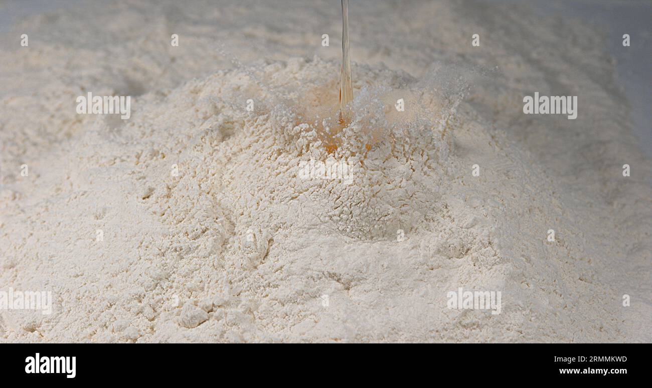 Egg Falling on Flour Stock Photo - Alamy