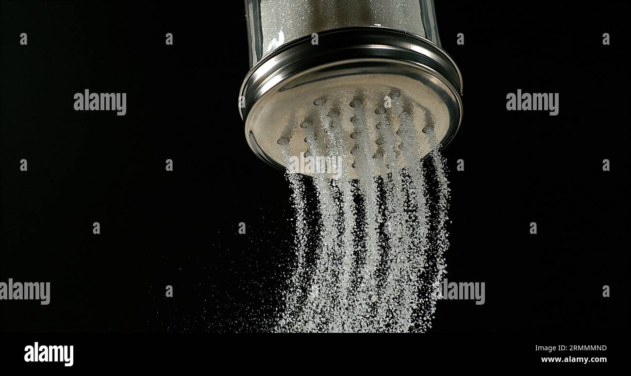 White Sugar falling against Black Background Stock Photo - Alamy