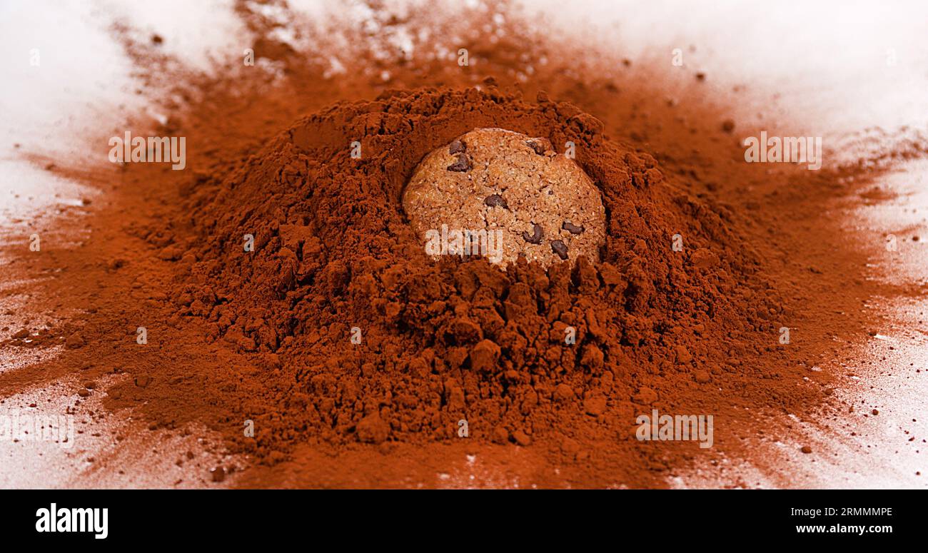 Cookie falling into Black Powder Chocolate Stock Photo - Alamy