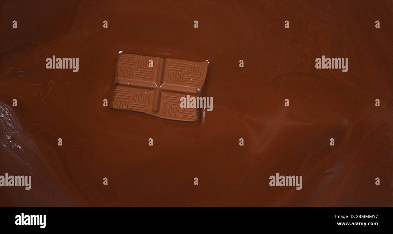 Chocolate tablet falling into Milk Chocolate Stock Photo - Alamy
