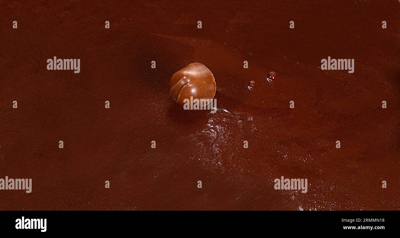 Chocolate falling into Milk Chocolate Stock Photo - Alamy