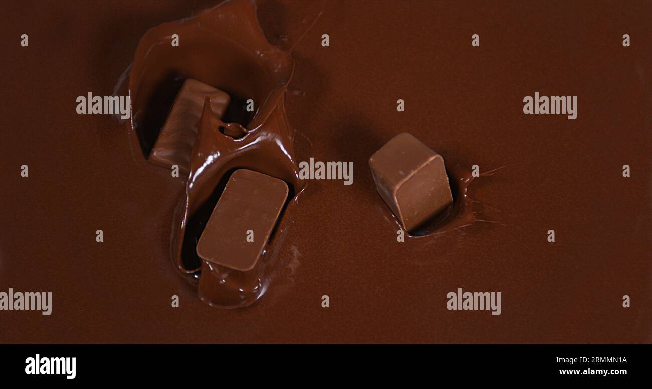 Chocolate falling into Milk Chocolate Stock Photo - Alamy