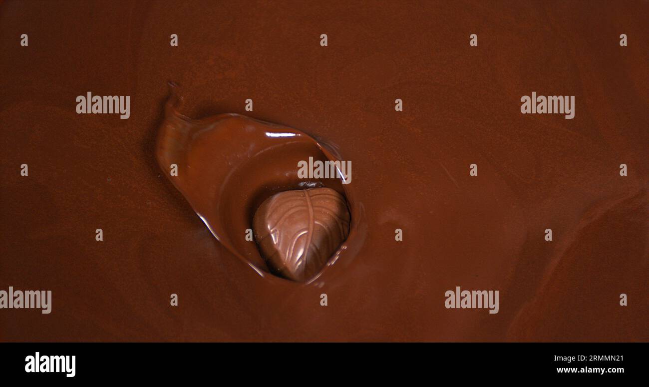 Chocolate falling into Milk Chocolate Stock Photo - Alamy