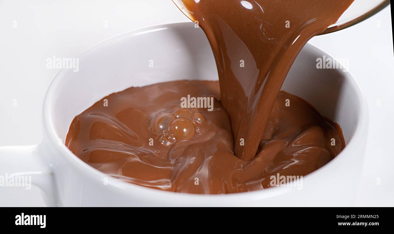 Chocolate Pouring into a Bowl against White Background Stock Photo - Alamy