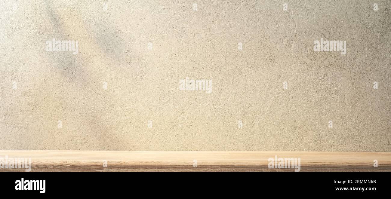 Sand-colored rough stone wall and wooden shelf in front of it. Kitchen ...