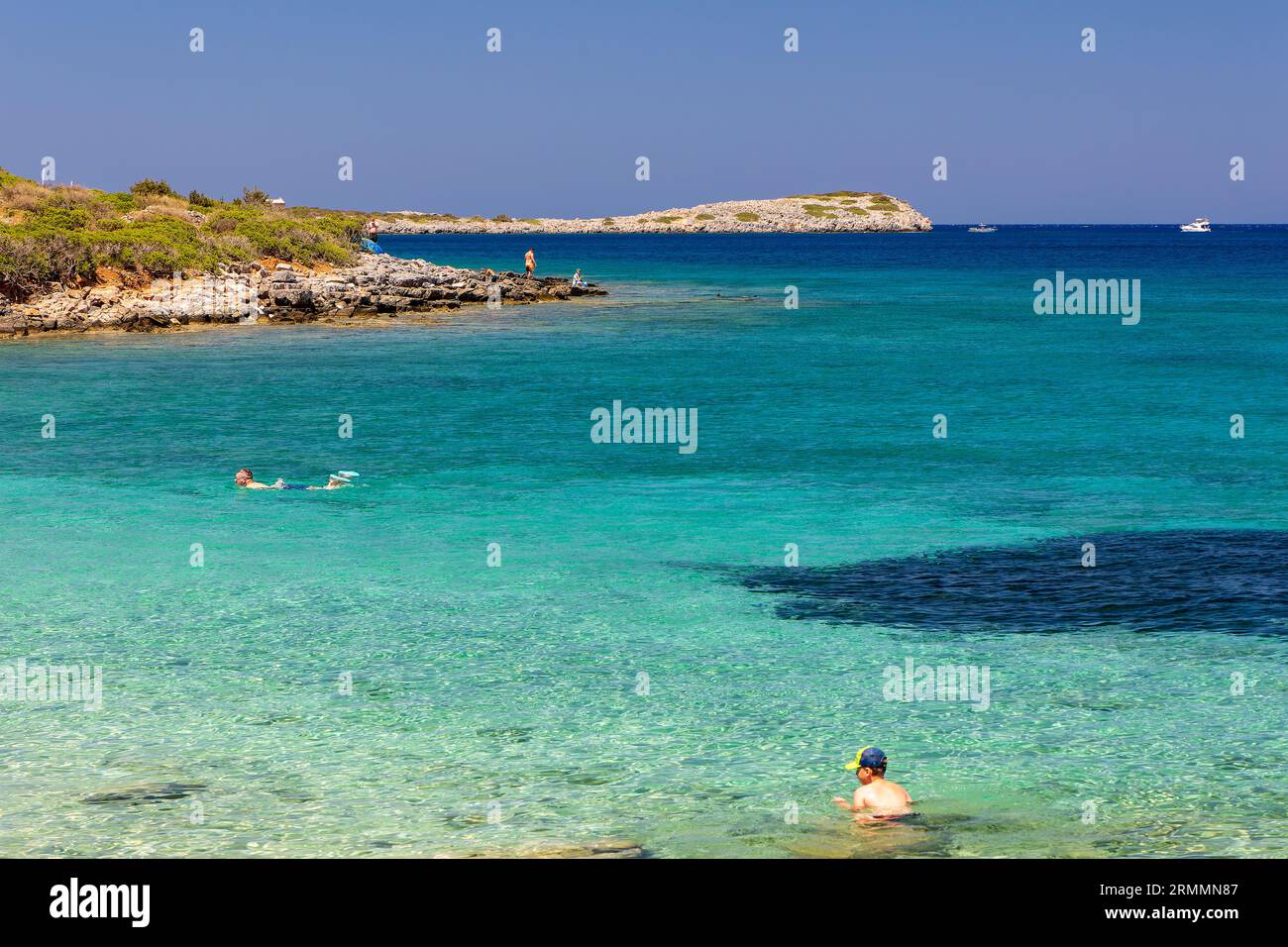 Swimmers enjoying the warm, crystal clear waters around Kolokitha, near ...