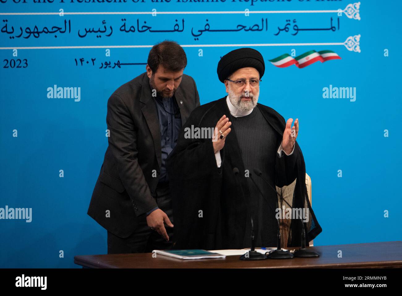 Iranian President Ebrahim Raisi waves to the media as he arrives before ...