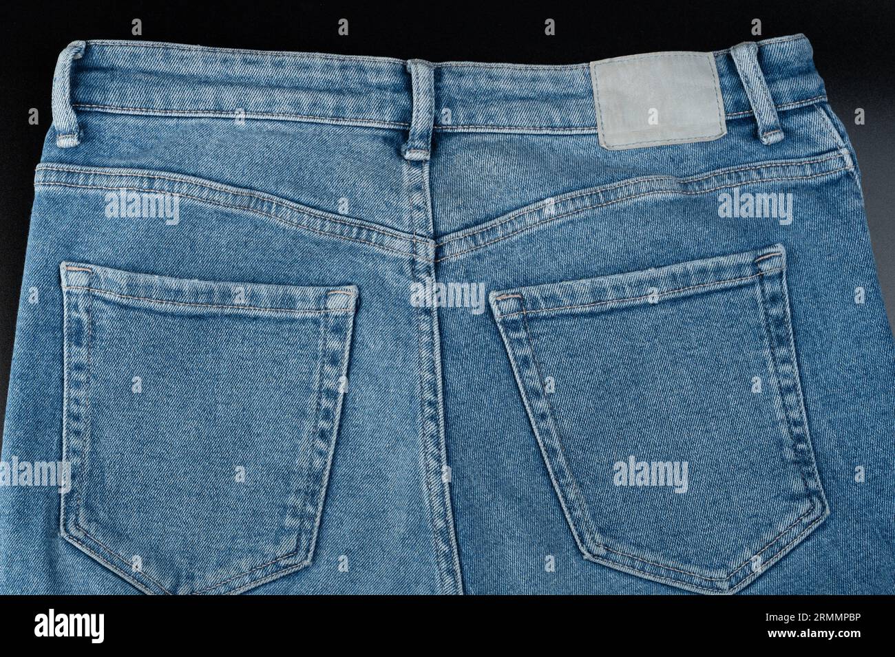 Rear view of jeans pants with pockets isolated on black studio ...