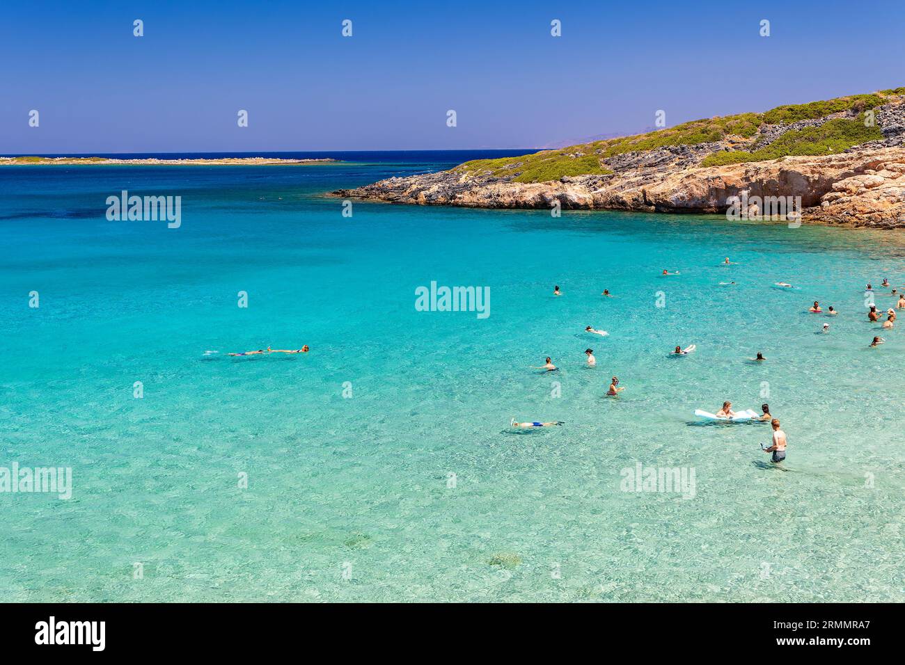 Swimmers enjoying the warm, crystal clear waters around Kolokitha, near ...