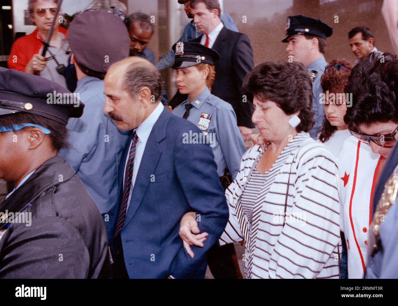 Rocco Fama, center left, and his wife Josephine leave court in New York ...