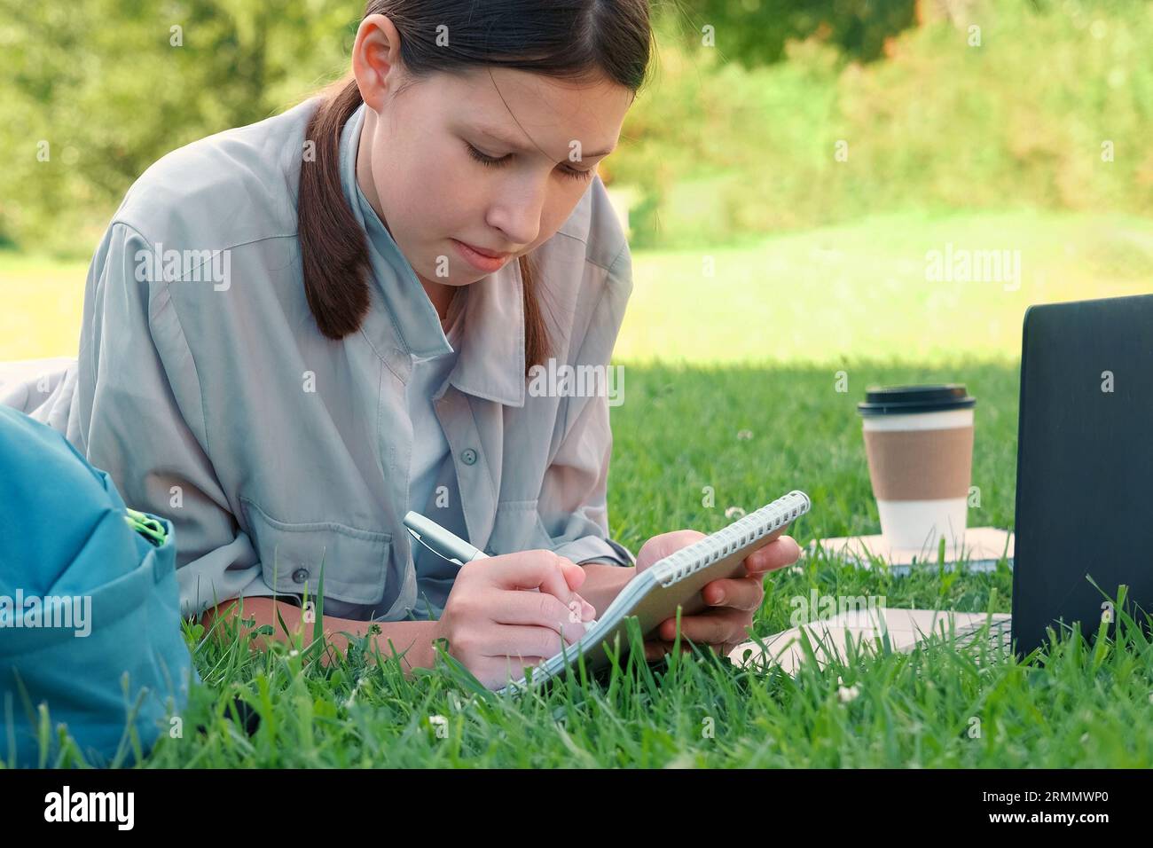 Teenage schoolgirl studying reading her books, tablet and notebook ...