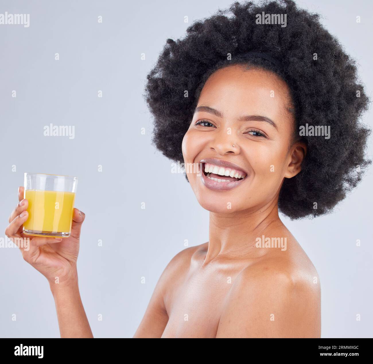 Woman, portrait and glass of orange juice in studio for vitamin c ...