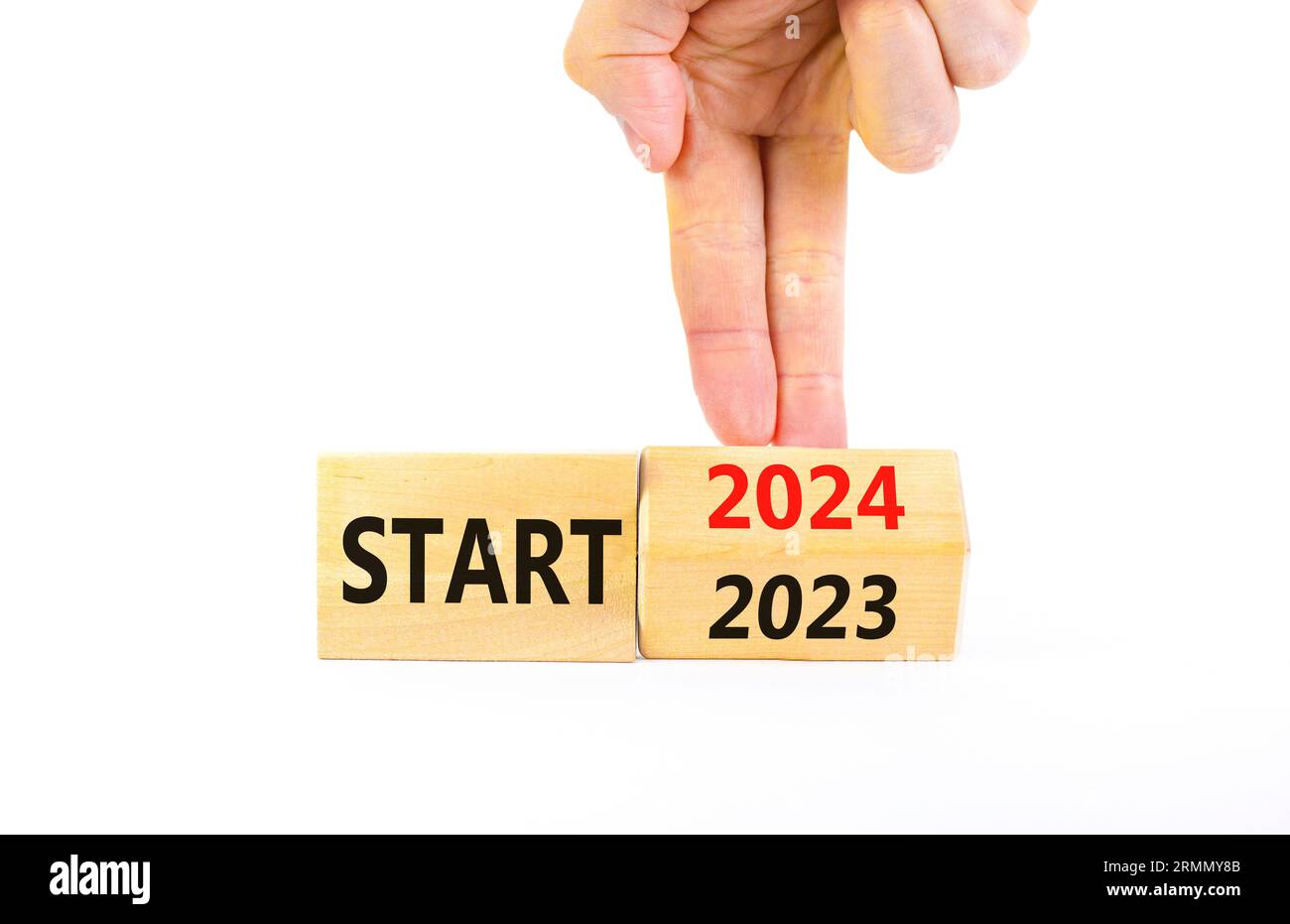 2024 start new year symbol. Businessman turns a wooden cube and changes ...