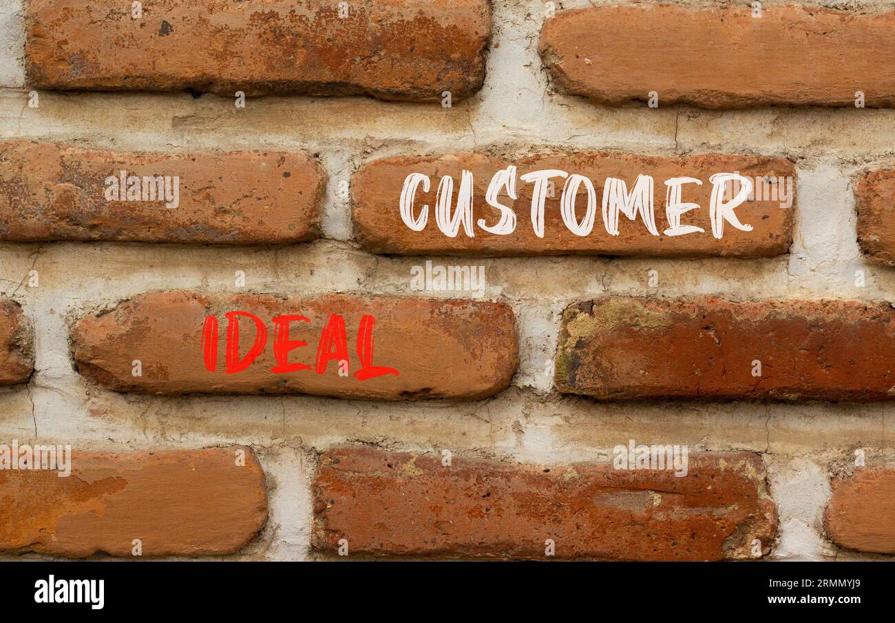 Ideal customer symbol. Concept words Ideal customer on beautiful brick ...