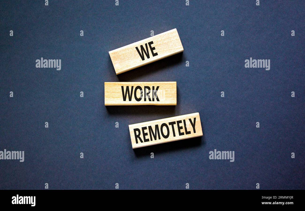 We work remotely symbol. Concept words We work remotely on wooden block ...