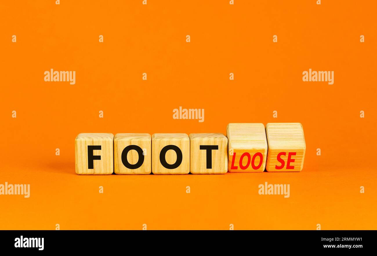 Foot or footloose symbol. Businessman turns wooden cubes and changes ...