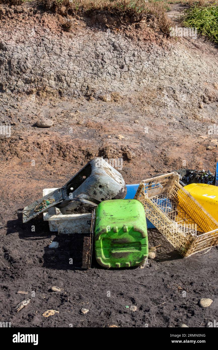 plastic waste products washed up on a beach. pollution with used ...