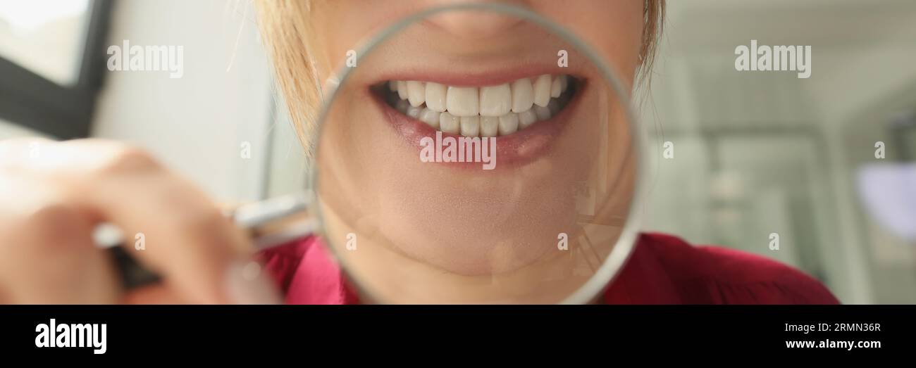 Woman young laughing mouth through a magnifying glass Stock Photo - Alamy