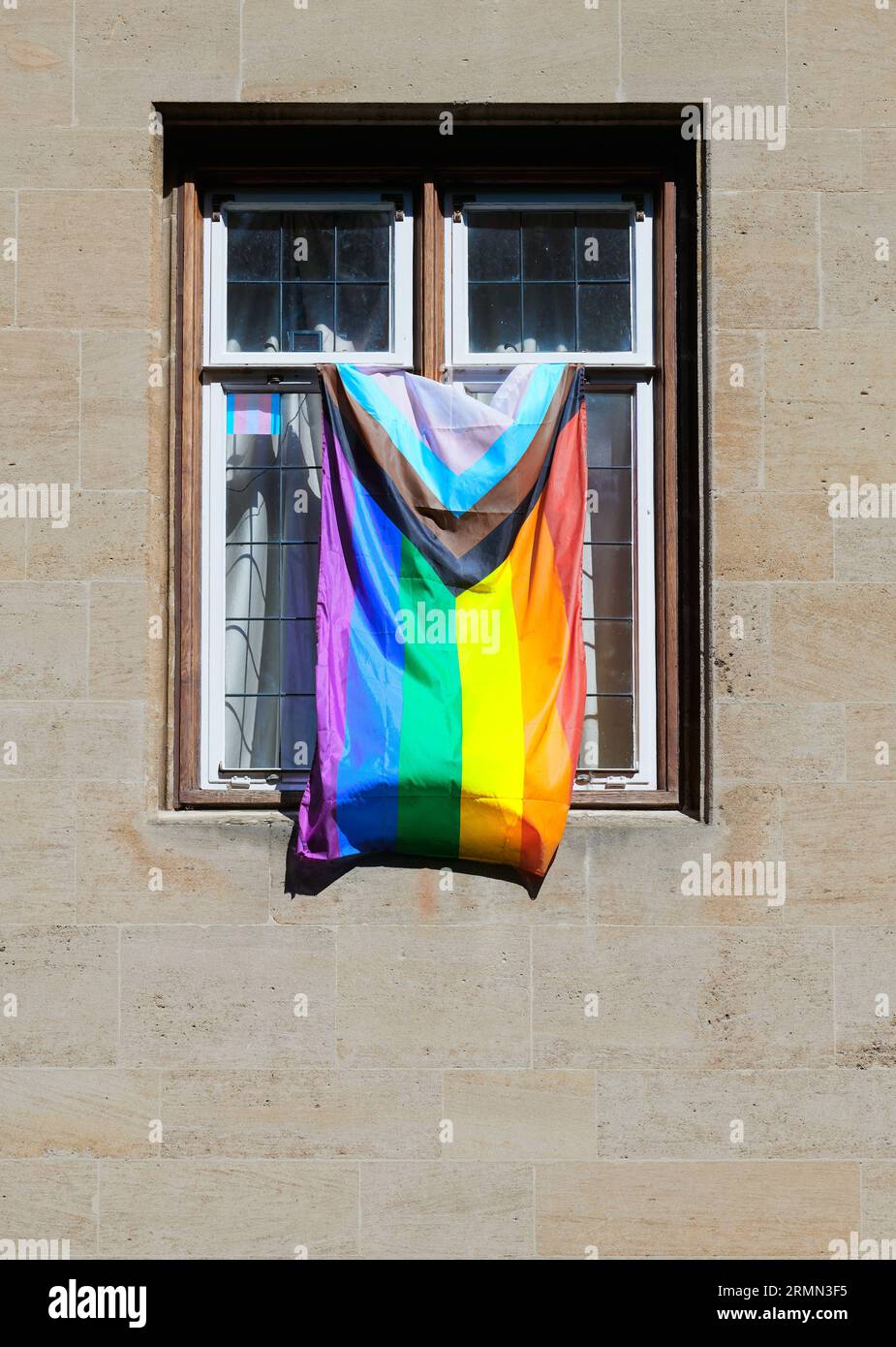 Gay flag on a window at King's College, University of Cambridge ...