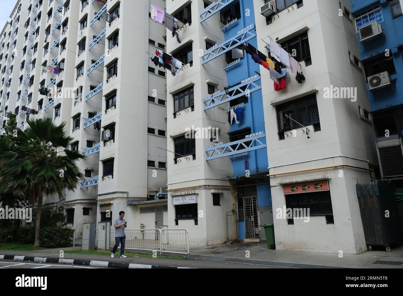 A man walks past Housing & Development Board public housing in ...