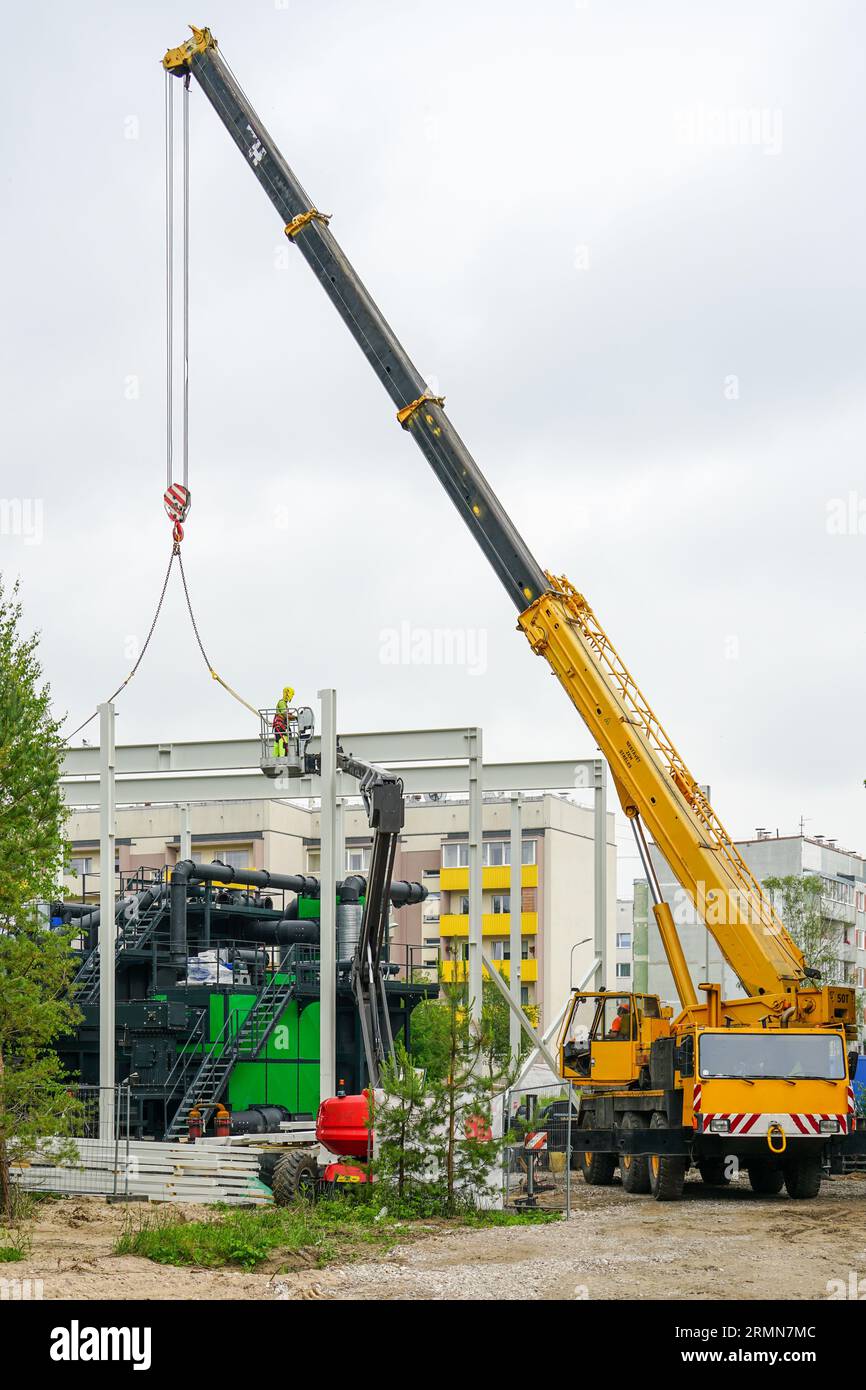 Metal frame mounting around new modern wood chip biofuel boiler using ...