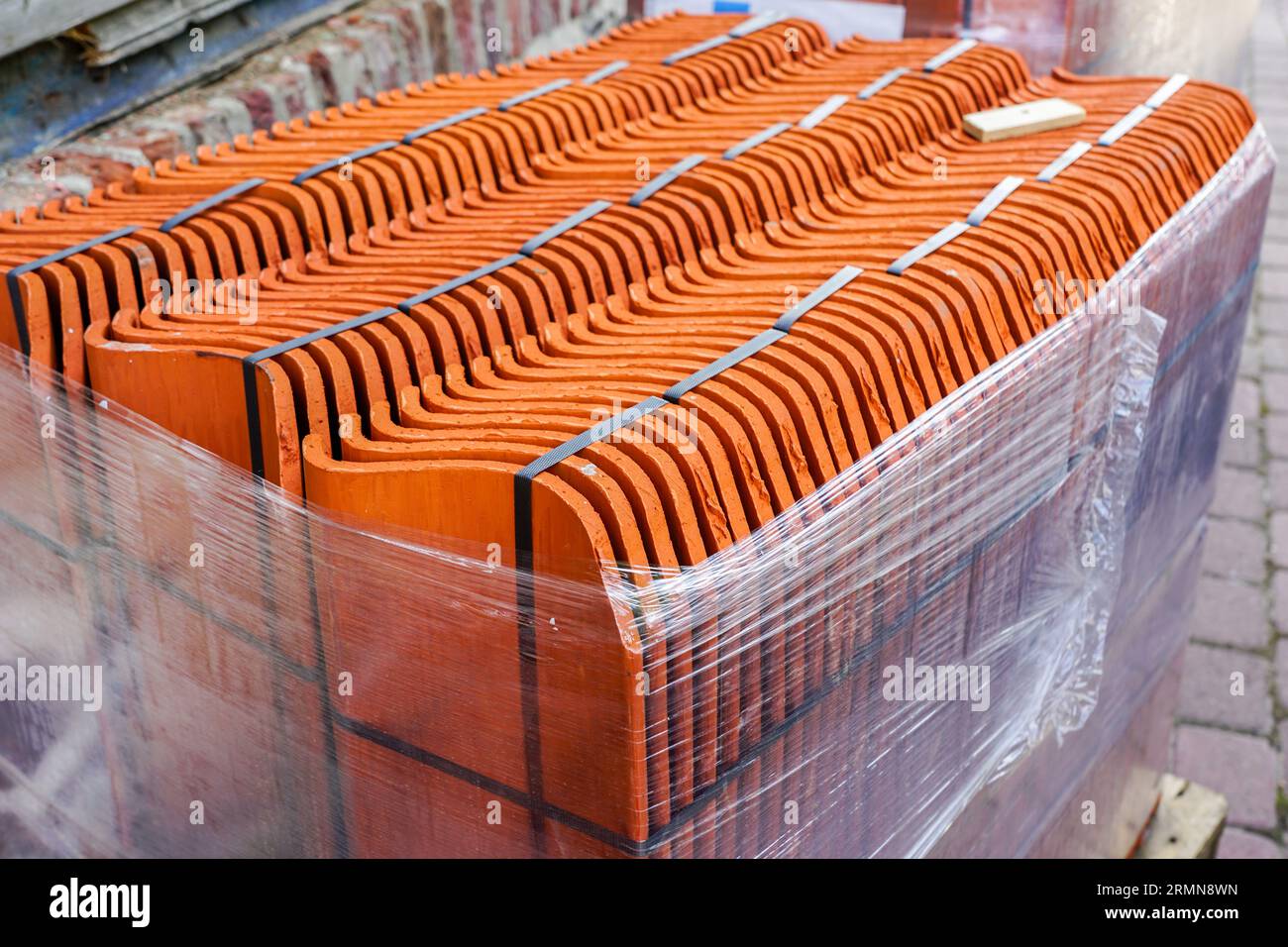 Wooden pallet with packed in rows new red brown roof clay tiles ...