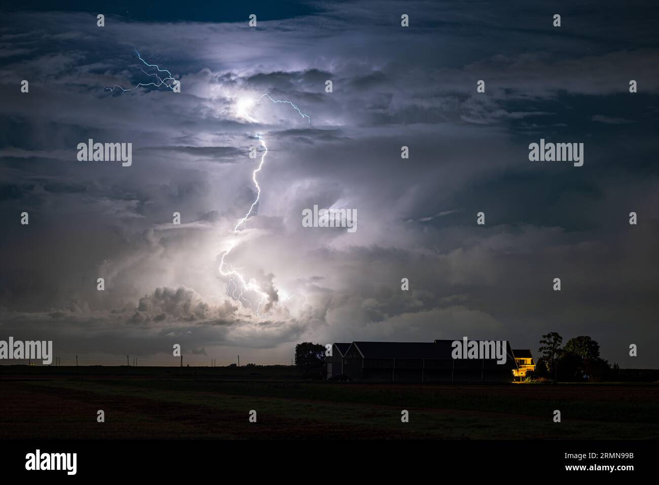 Lightning bolt from the top of a thundercloud at night Stock Photo - Alamy