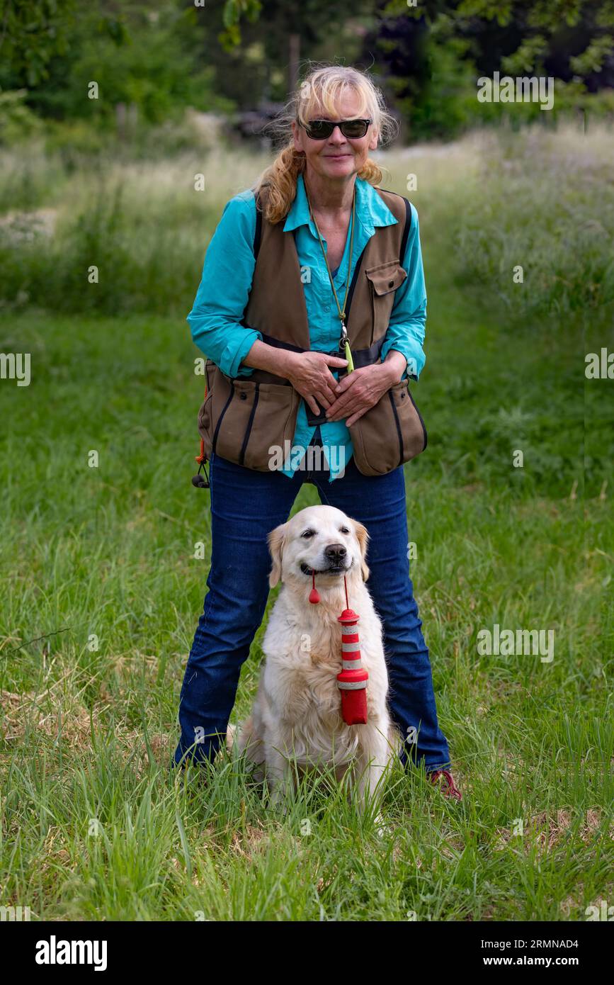 Woman with her Golden Retriever doing obedience Training Stock Photo ...