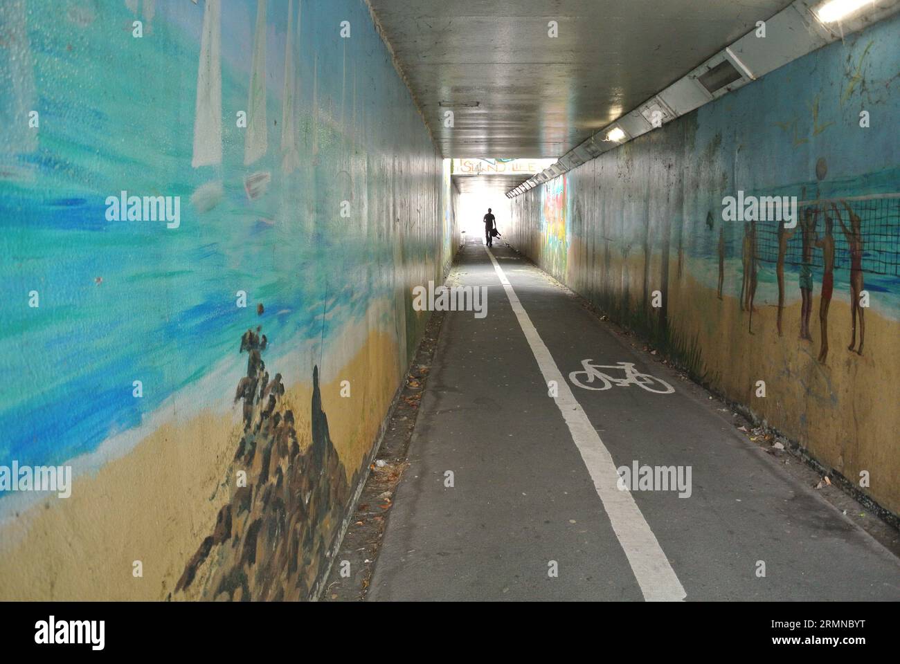 Subway tunnel under four lanes of traffic. Mural and graffiti style ...