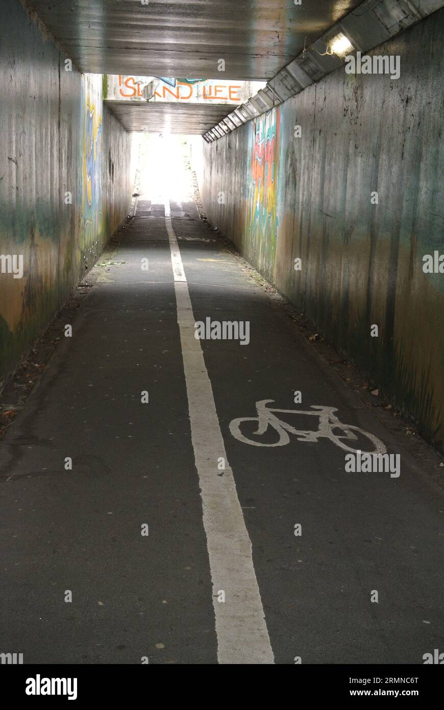 Subway tunnel under four lanes of traffic. Mural and graffiti style ...