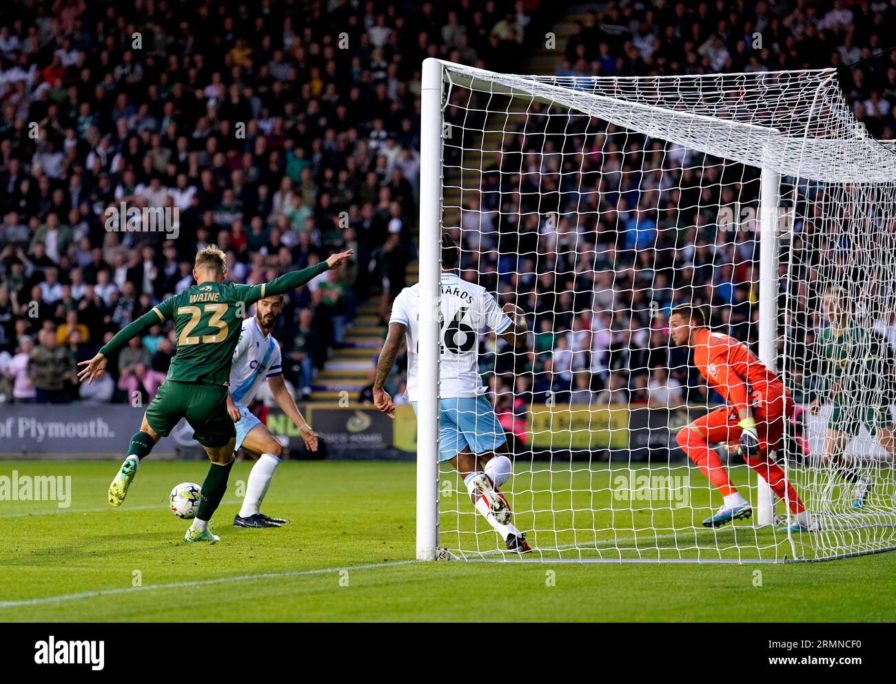 Plymouth Argyle's Ben Waine (left) scores their side's first goal of ...