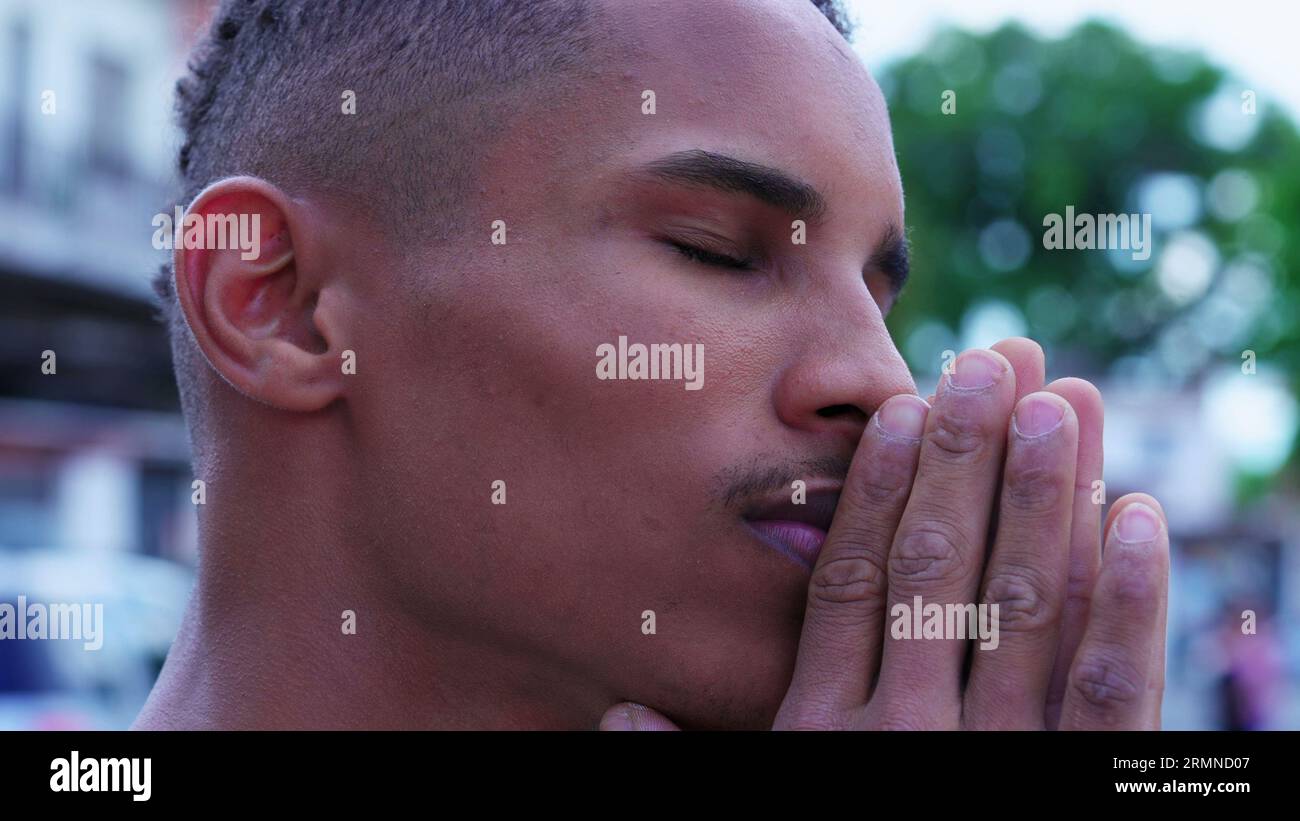 One spiritual young black man in Prayer in sunlight. Brazilian Devout ...