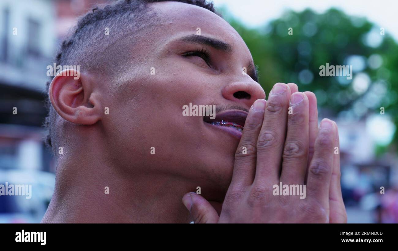 One spiritual young black man in Prayer in sunlight. Brazilian Devout ...