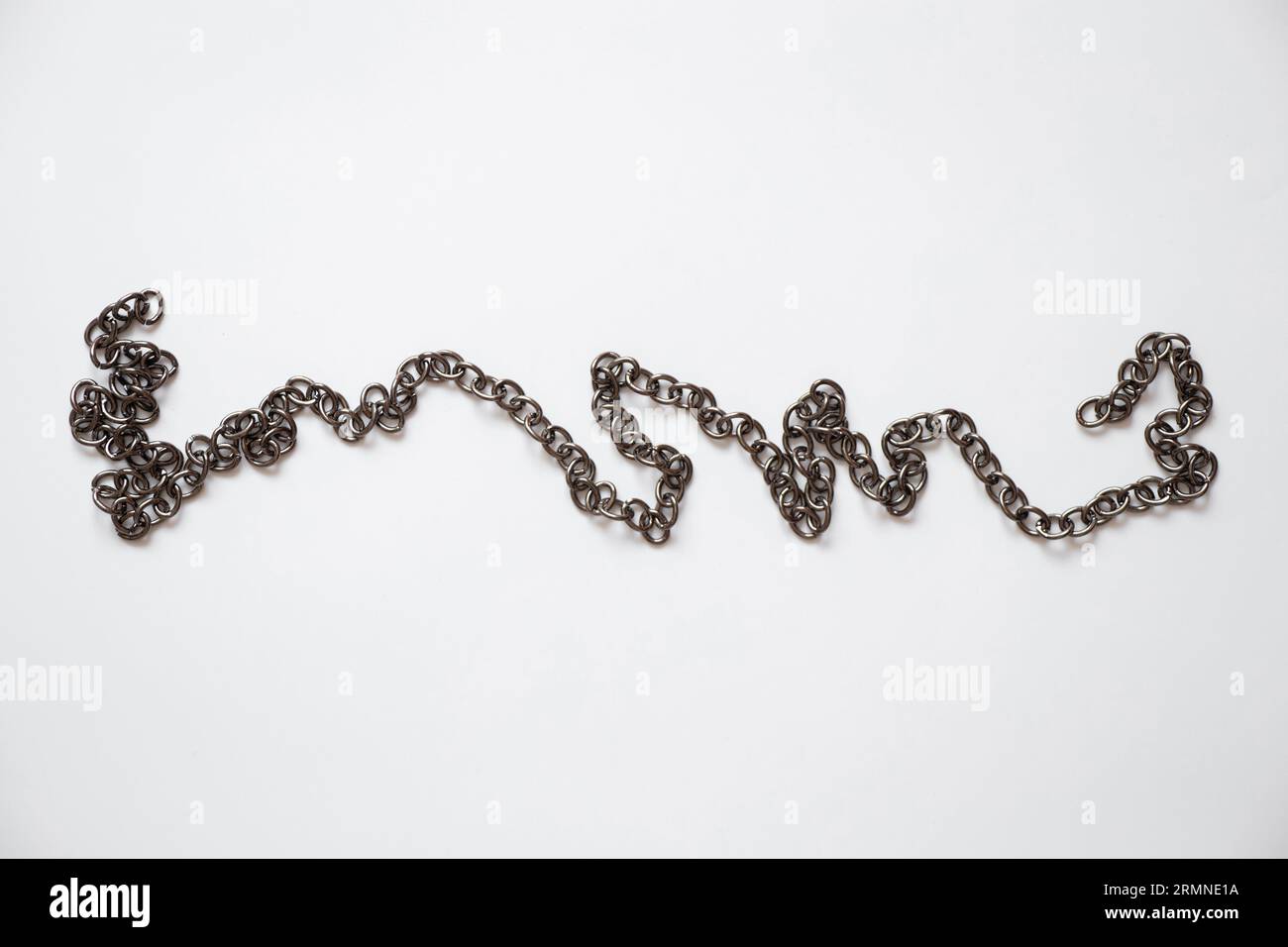 The chain lies on a white background close-up Stock Photo - Alamy