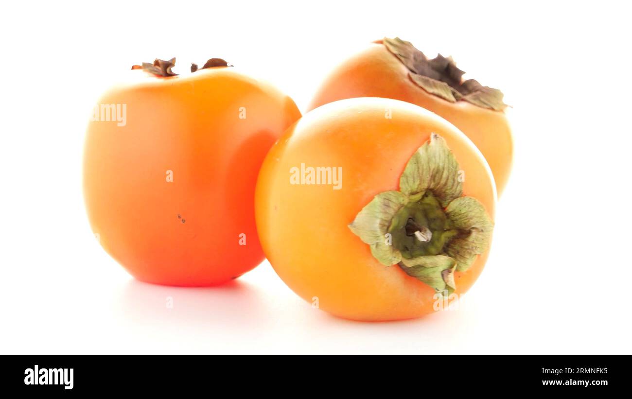 Red ripe persimmons rotating over white background Stock Photo - Alamy