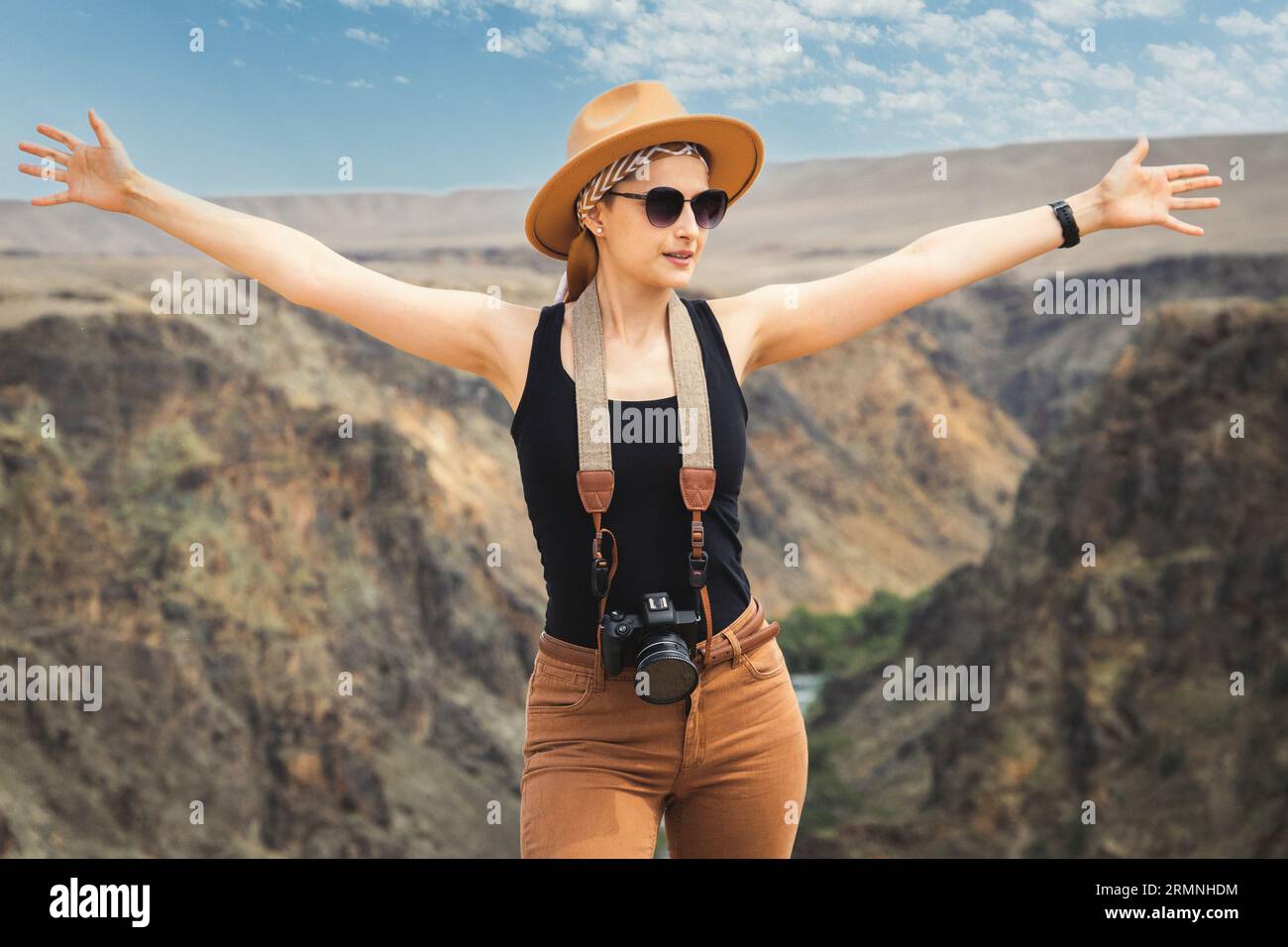 A woman tourist with a camera travels along the upper part of the ...