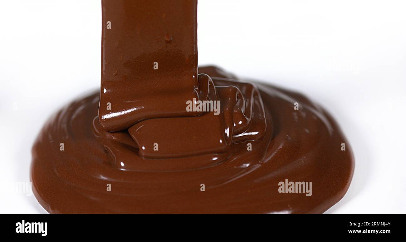Chocolate Flowing on White Background Stock Photo - Alamy