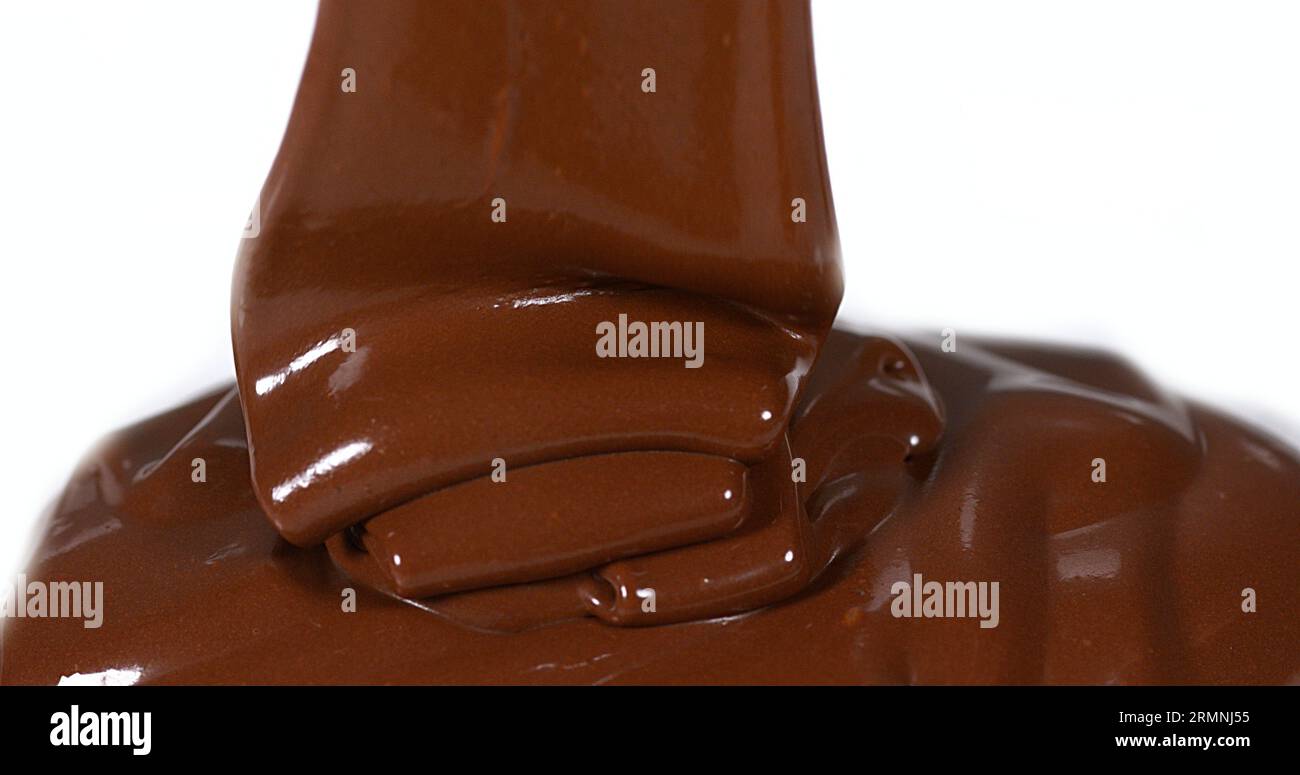 Chocolate Flowing on White Background Stock Photo - Alamy