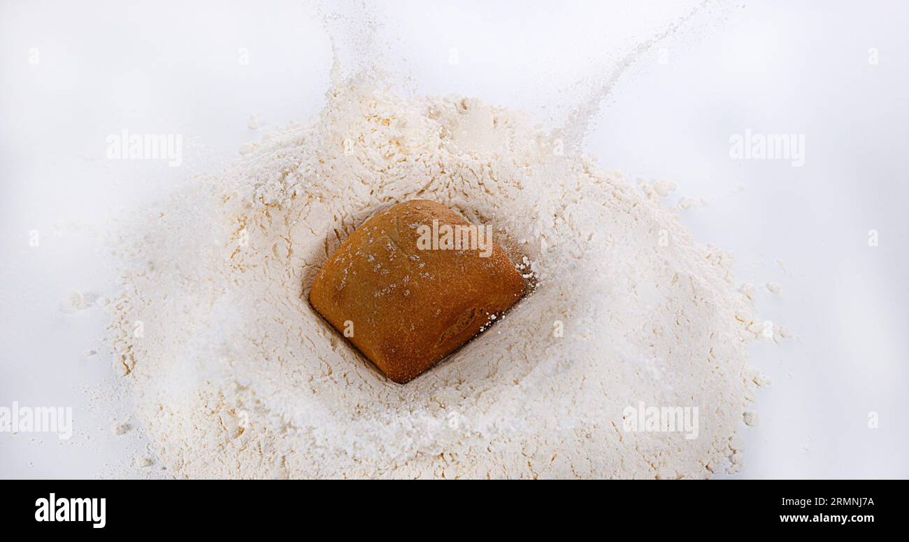 Bread Falling in Flour against White Background Stock Photo - Alamy