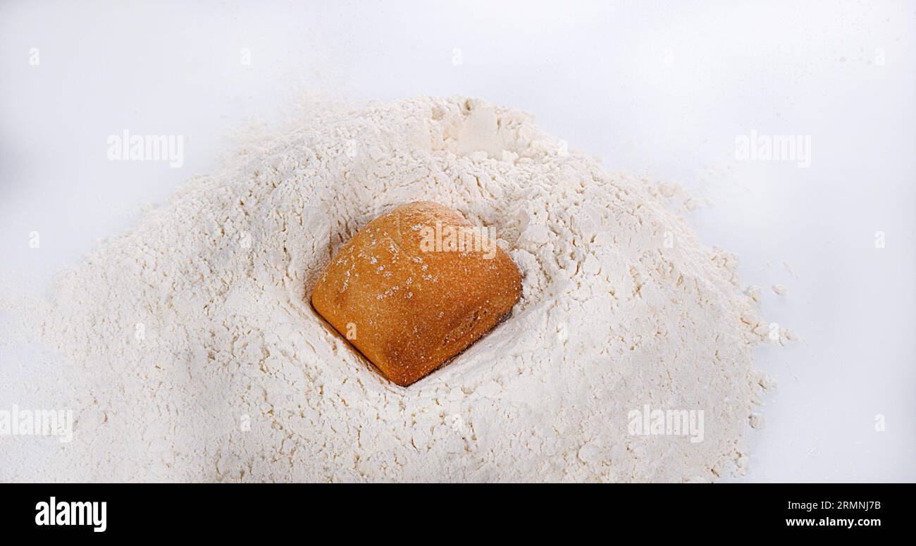 Bread Falling in Flour against White Background Stock Photo - Alamy