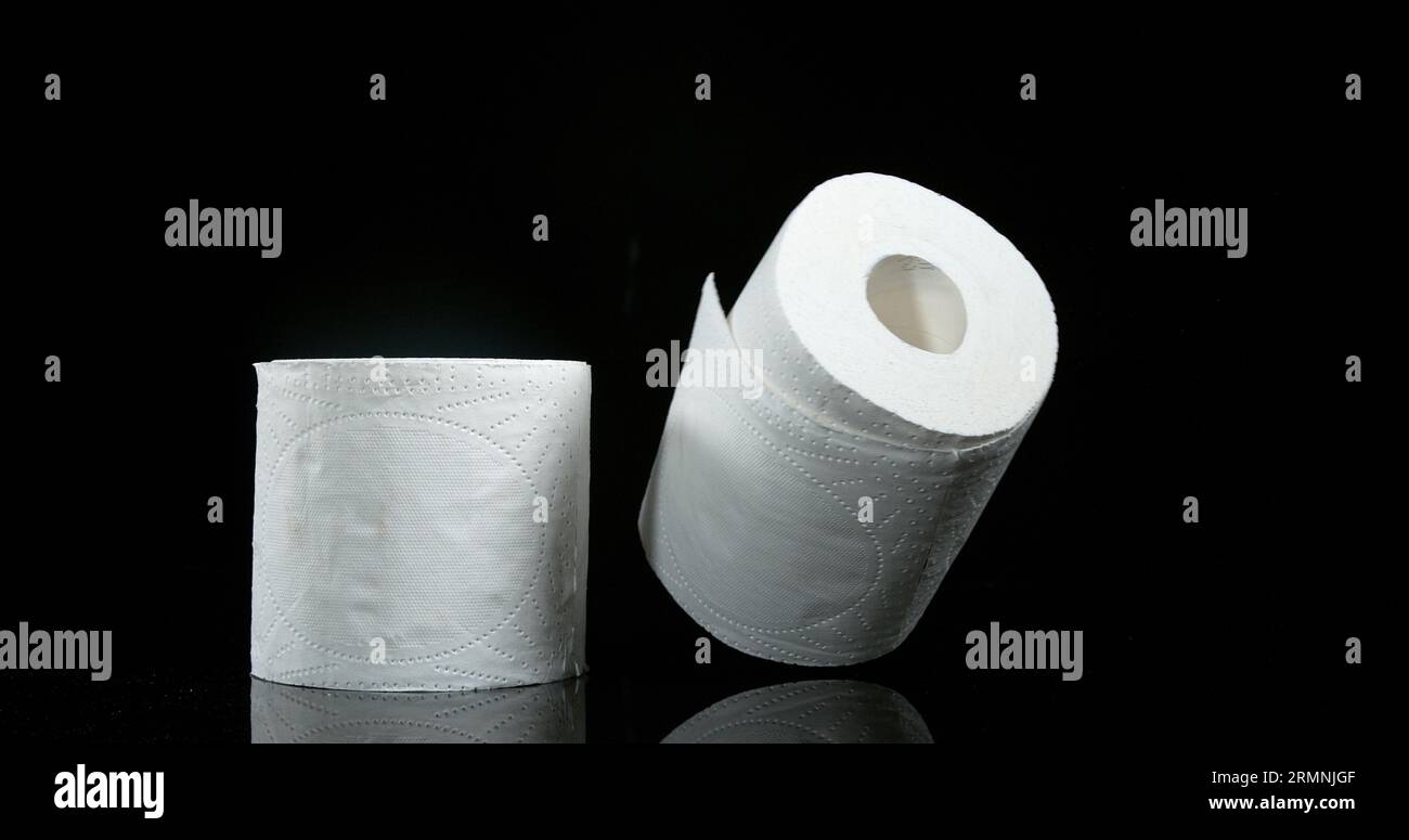 Roll of Toilet Paper Falling on Black Background Stock Photo - Alamy
