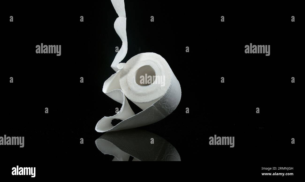 Roll of Toilet Paper Falling on Black Background Stock Photo - Alamy