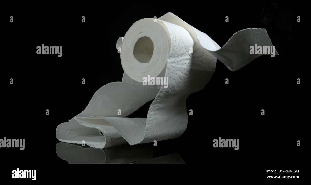 Roll of Toilet Paper Falling on Black Background Stock Photo - Alamy
