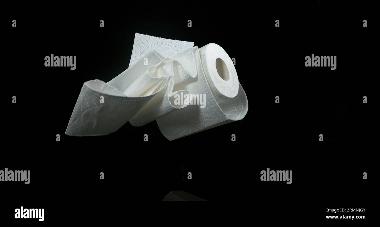 Roll of Toilet Paper Falling on Black Background Stock Photo - Alamy