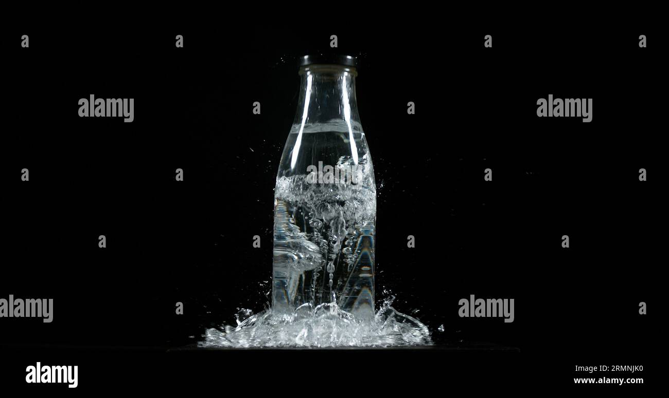 Bottle Falling and exploding on Black Background Stock Photo - Alamy