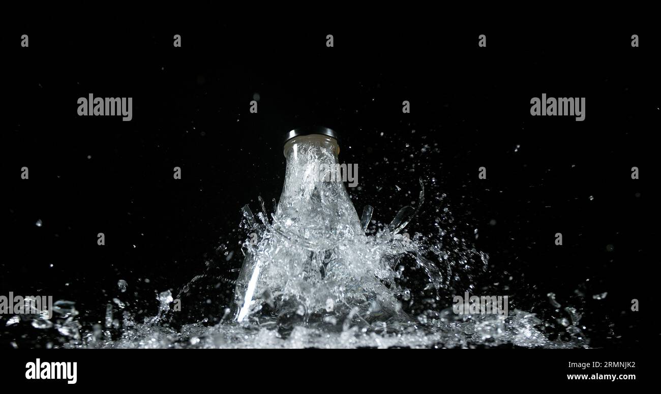 Bottle Falling and exploding on Black Background Stock Photo - Alamy