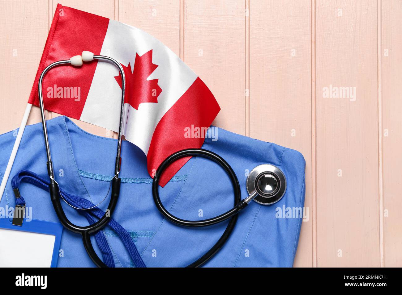 Canadian flag with doctor's uniform, badge and stethoscope on beige ...